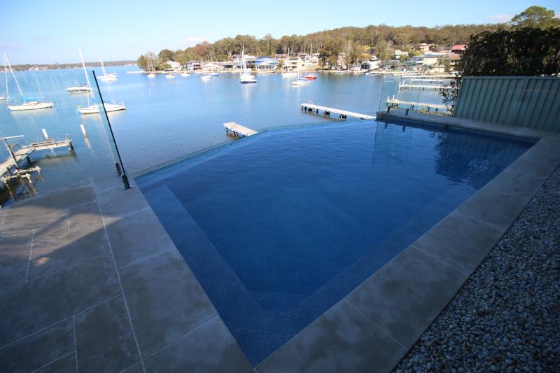 Mastering Challenges: Custom Pool with Luxurious Glass Wall Finish ...