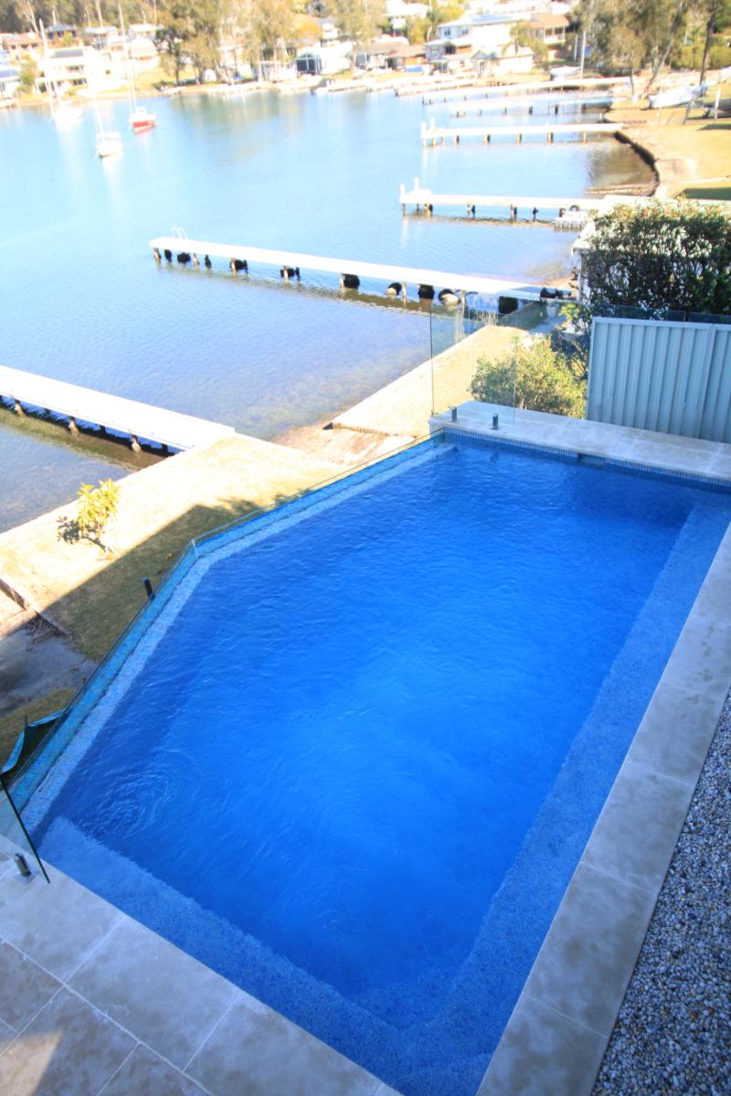 Mastering Challenges: Custom Pool with Luxurious Glass Wall Finish ...